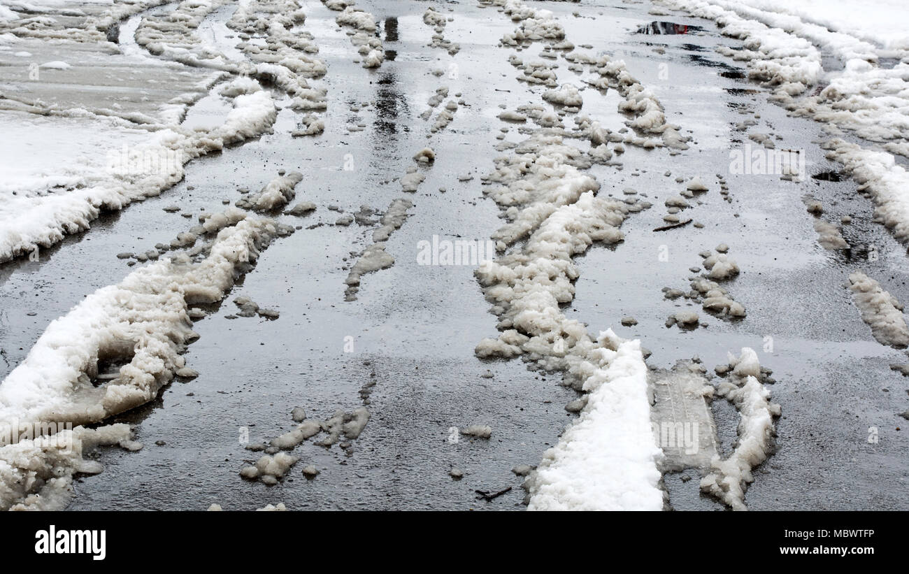 Dirty melted snow on the road creates real problems Stock Photo - Alamy