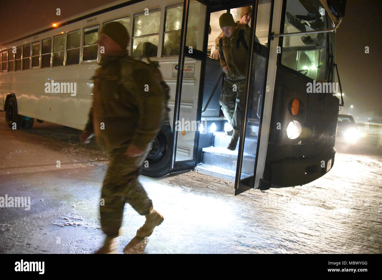 Members of the 119th Civil Engineer Squadron get off a bus upon ...