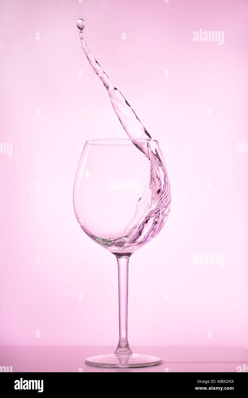 The drink spills out of the glass Stock Photo - Alamy