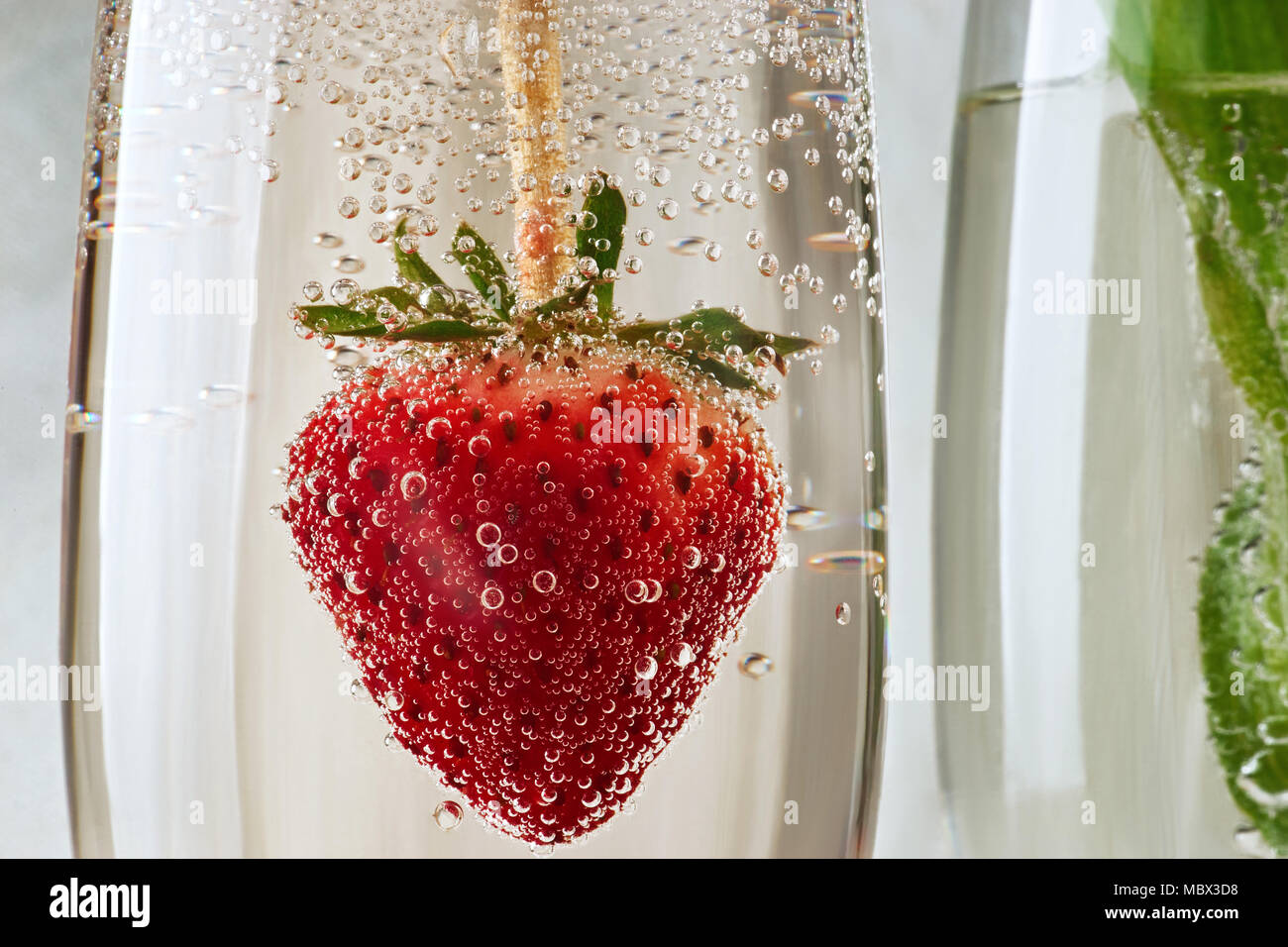 Strawberry inside a glass with champagne Stock Photo - Alamy