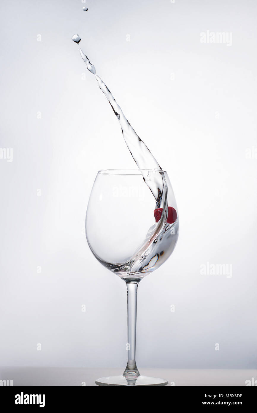 The drink spills out of the glass Stock Photo - Alamy