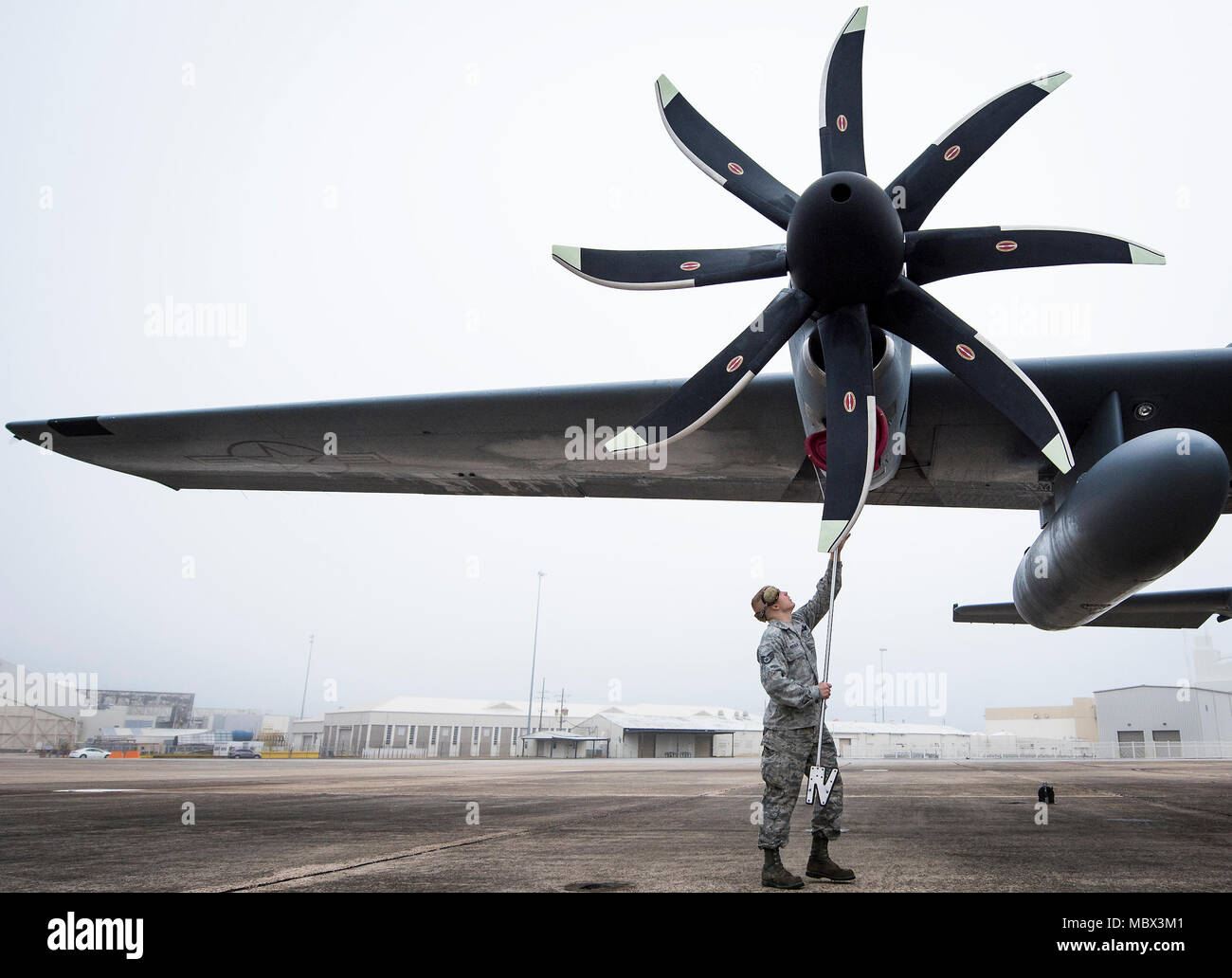 Staff Sgt. Ethan Mulhern, 153rd Airlift Wing maintainer, places a cover ...