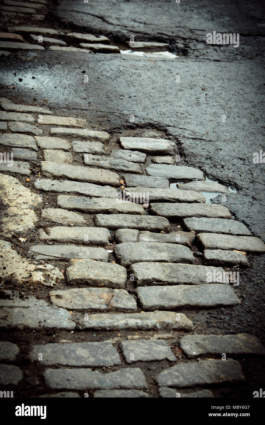 Old New York City cobblestone street repaired with asphalt Stock Photo ...