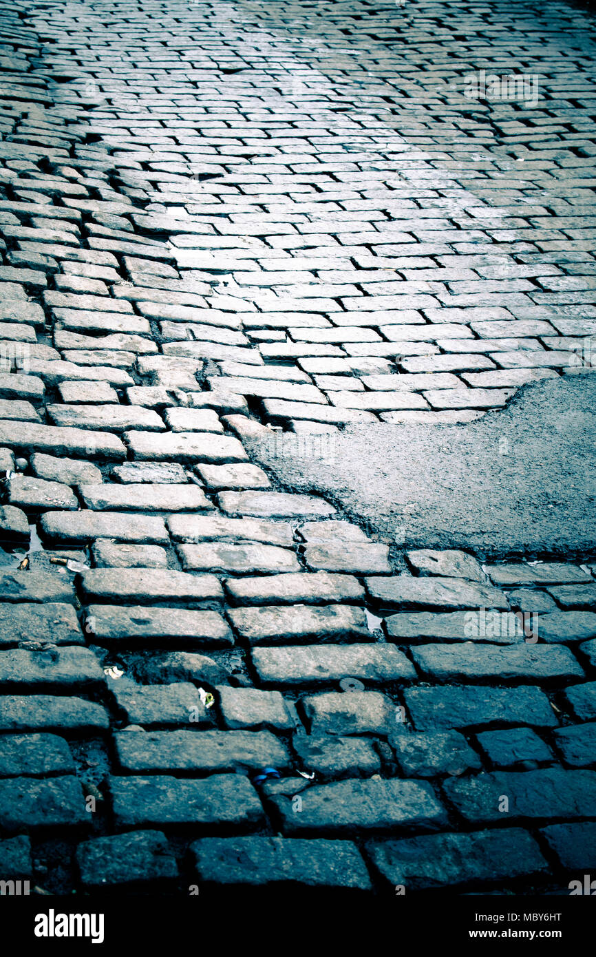 Old New York City cobblestone street repaired with asphalt Stock Photo ...
