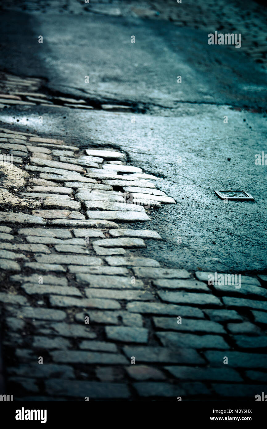 Old New York City cobblestone street repaired with asphalt Stock Photo ...