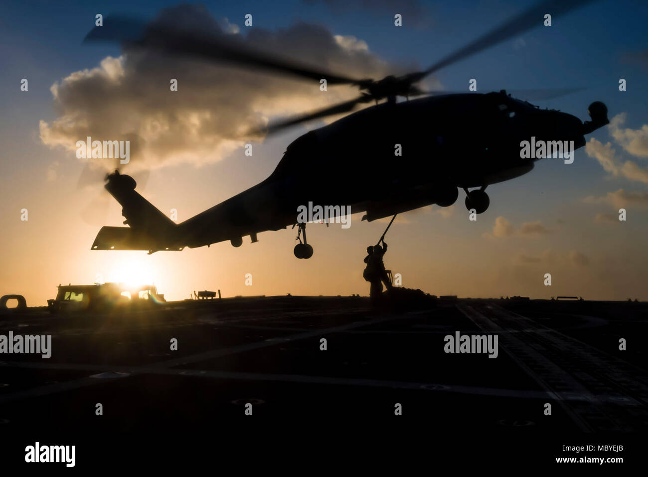 PACIFIC OCEAN (Oct. 17, 2017) Sailors attach pallets to an MH-60R Sea ...