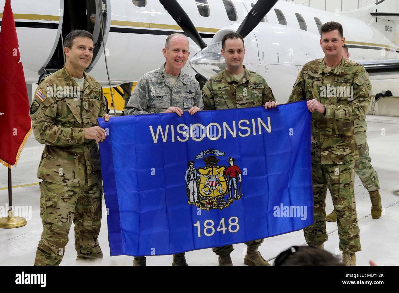 Maj. Gen. Don Dunbar, Wisconsin's adjutant general, presents the state ...