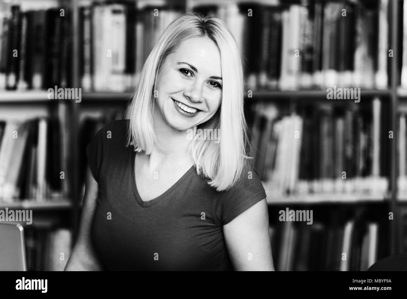 Pretty Female Student With Books Working in a High School Library Stock ...