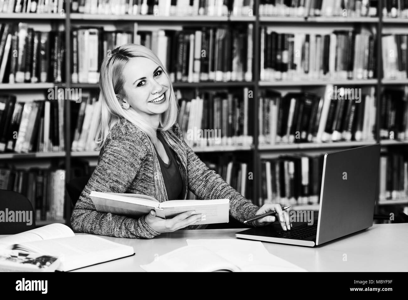 Portrait of an Attractive Student Doing Some School Work With a Laptop ...