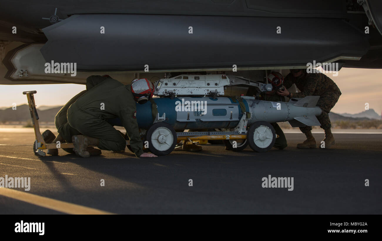 U.S. Marines with Marine Aviation Weapons and Tactics Squadron 1 load a ...