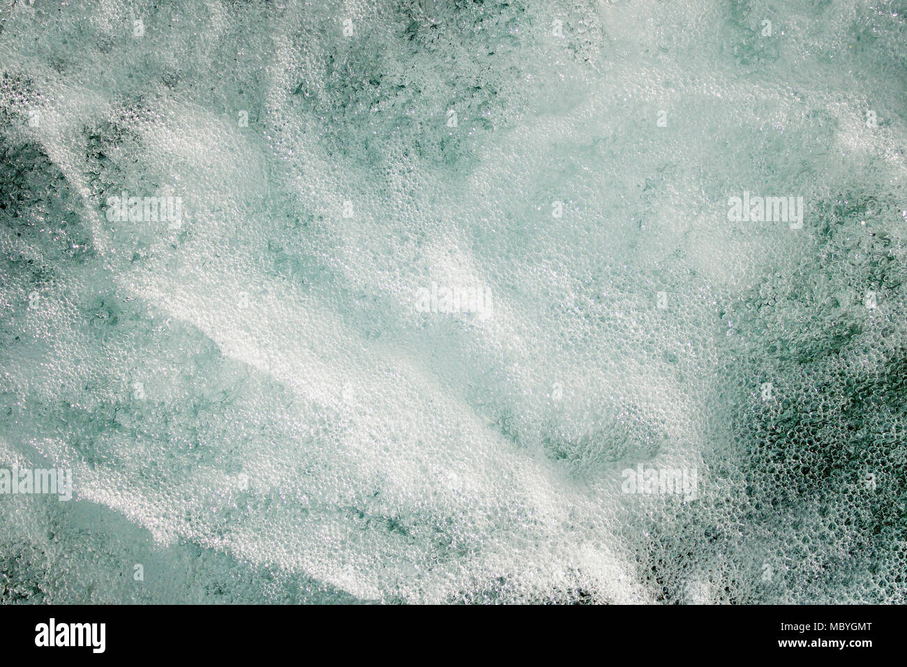 Strong boiling of water under mountain waterfall Stock Photo - Alamy