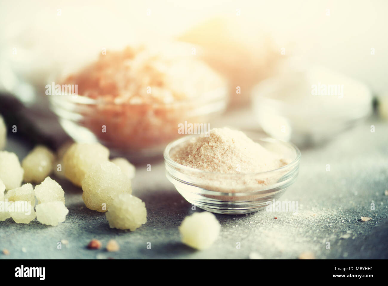 Mix of different salt types on grey concrete background. Sea salts ...