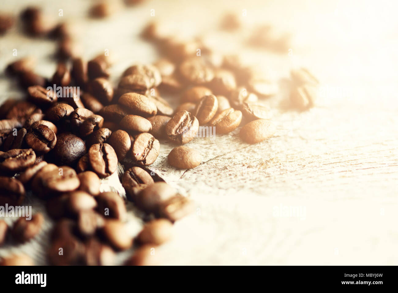 Coffee beans on light wooden background with copyspace for text. Coffee ...