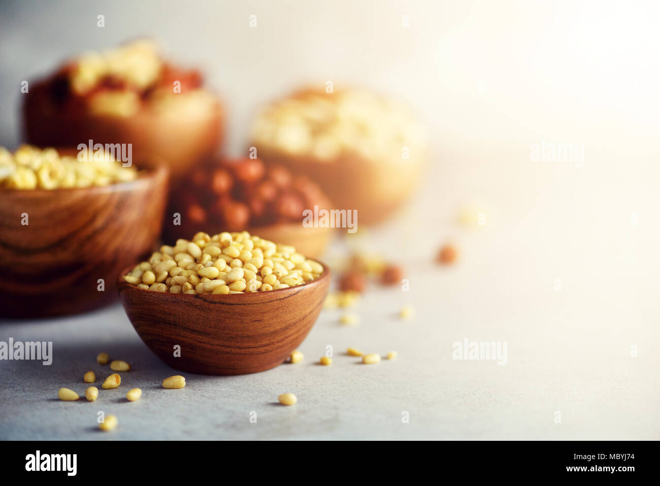 Pine nuts in wooden bowl. Food mix background, top view, copy space ...