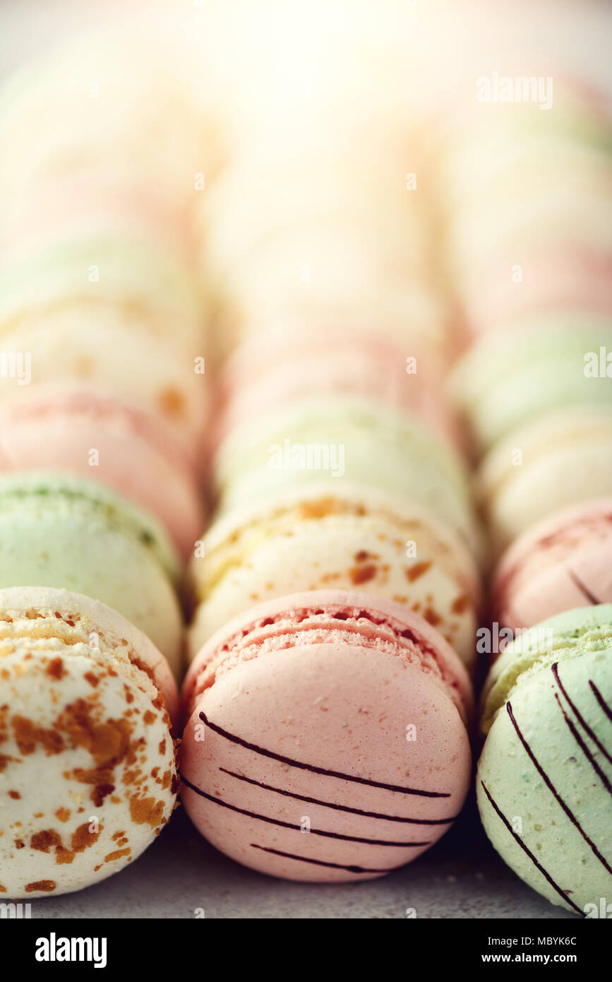 Colorful french macaroons flat lay. Pastel colors pink, green, yellow ...