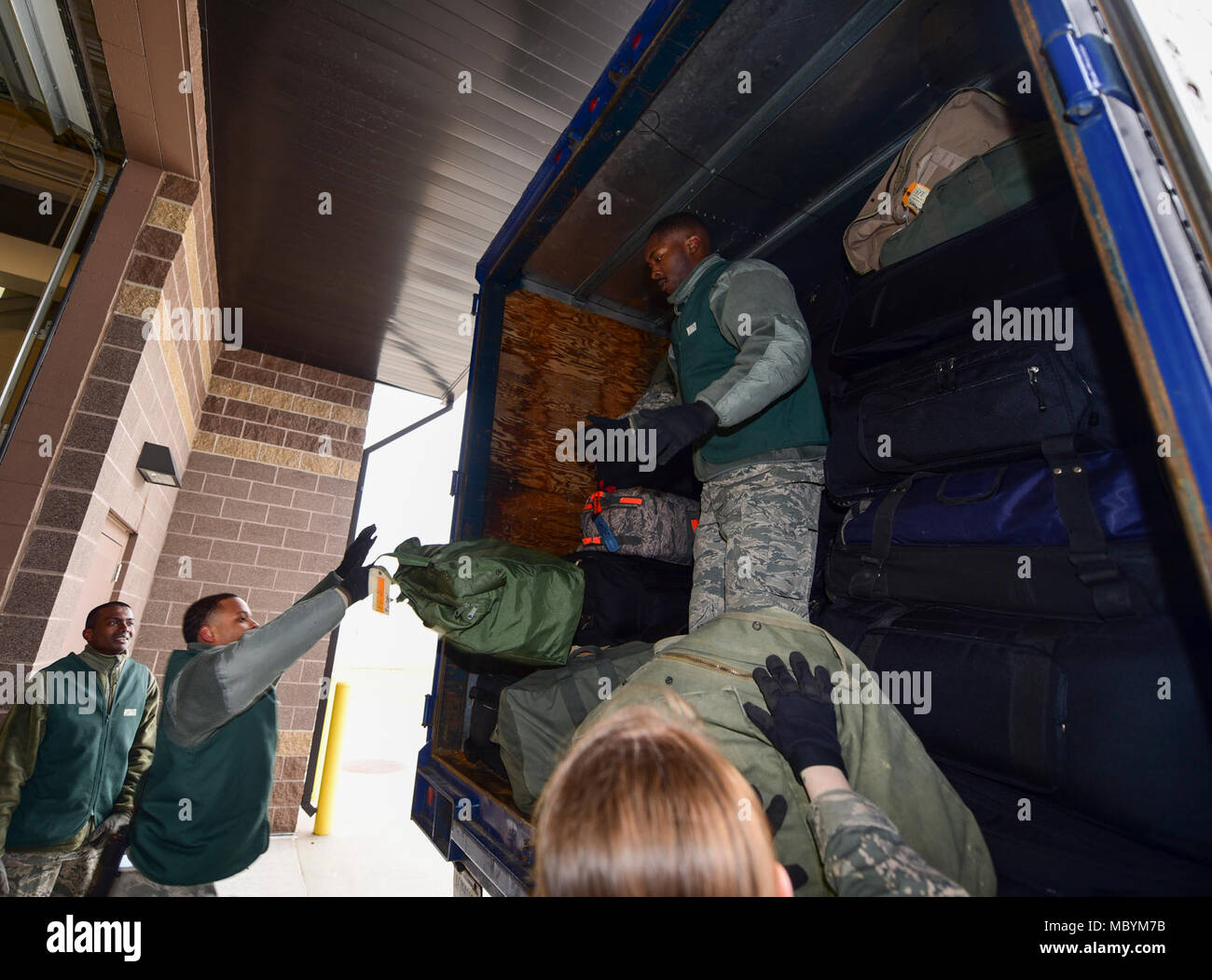 Airmen load bags into a truck during a deployment line at Ellsworth Air ...