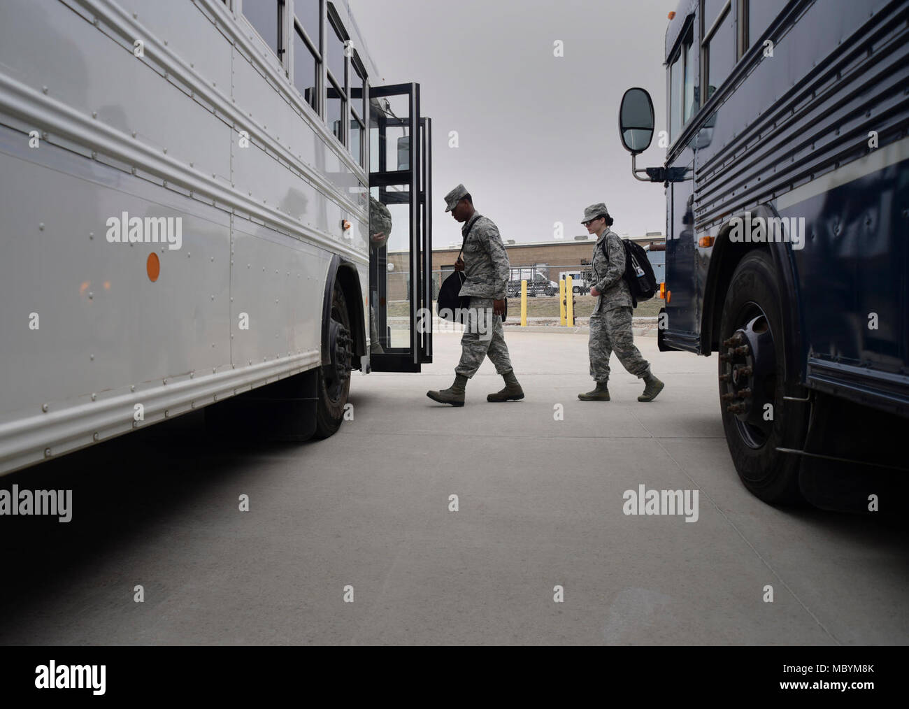 Airmen load onto a bus during a deployment line at Ellsworth Air Force ...