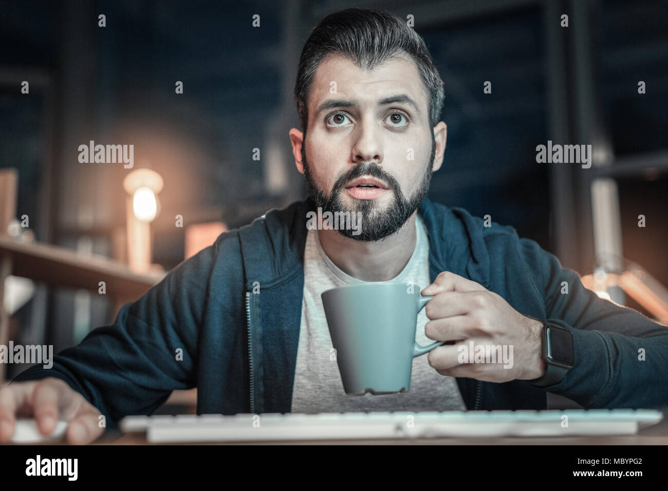 Bearded IT guy learning programming language Stock Photo - Alamy