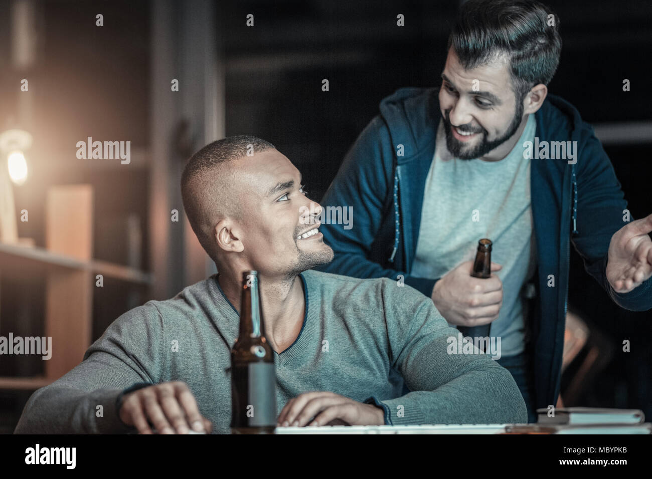 Happy two colleagues discussing program Stock Photo - Alamy