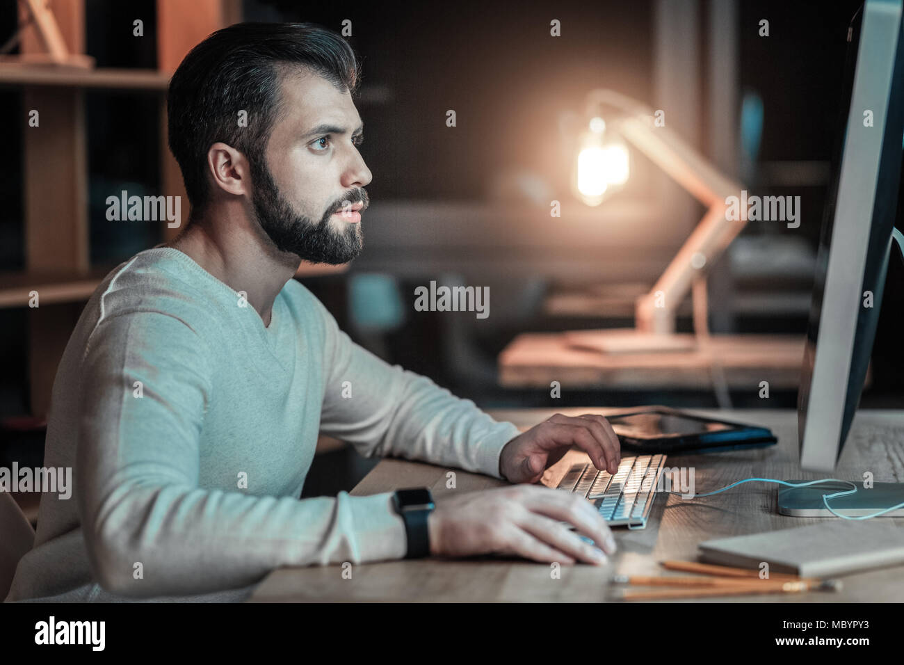 Musing IT guy choosing software Stock Photo - Alamy