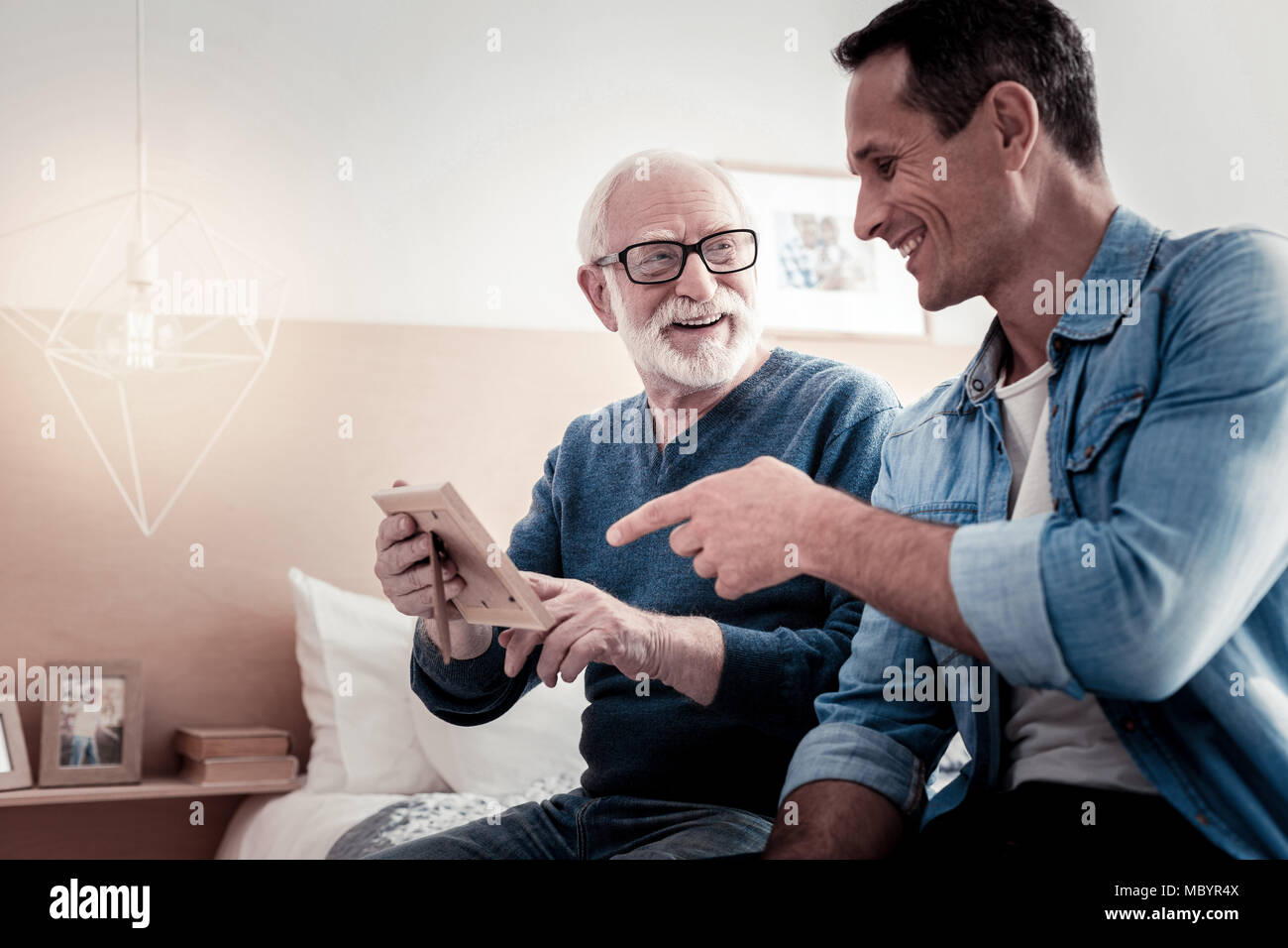 Happy positive man pointing at the photo Stock Photo - Alamy