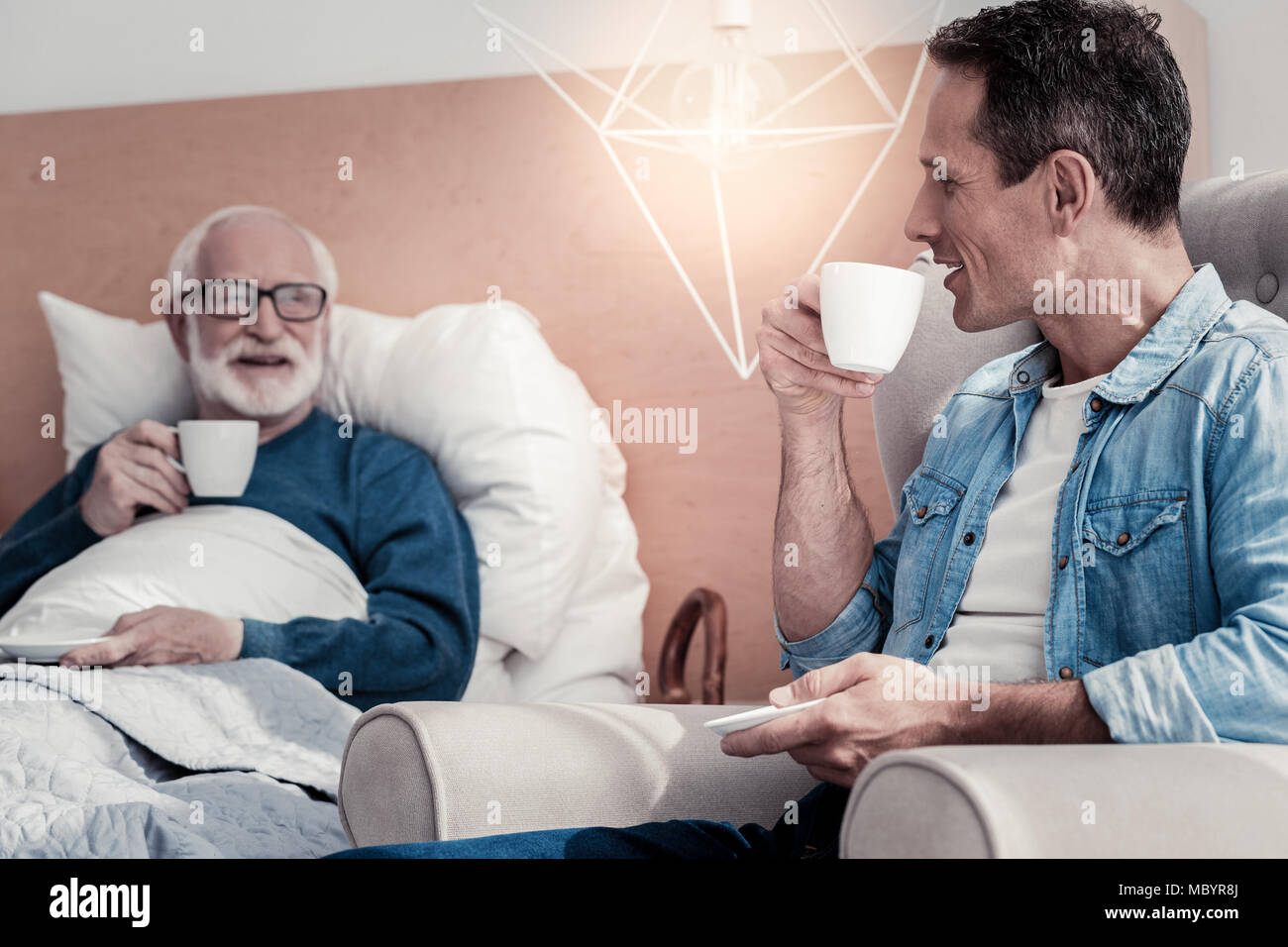 Handsome young man drinking tea Stock Photo - Alamy