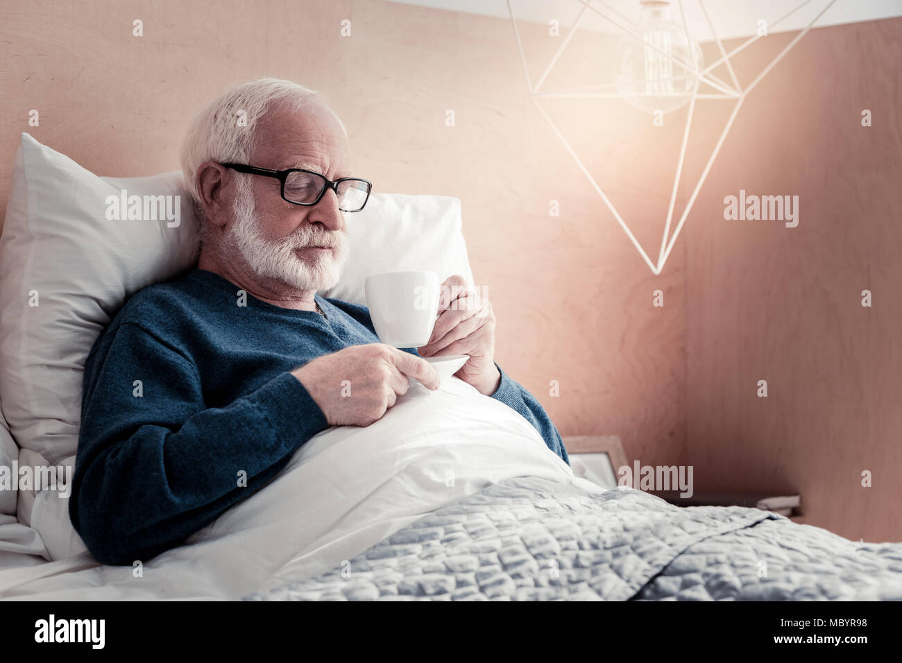 Nice elderly man lying in the bed Stock Photo - Alamy