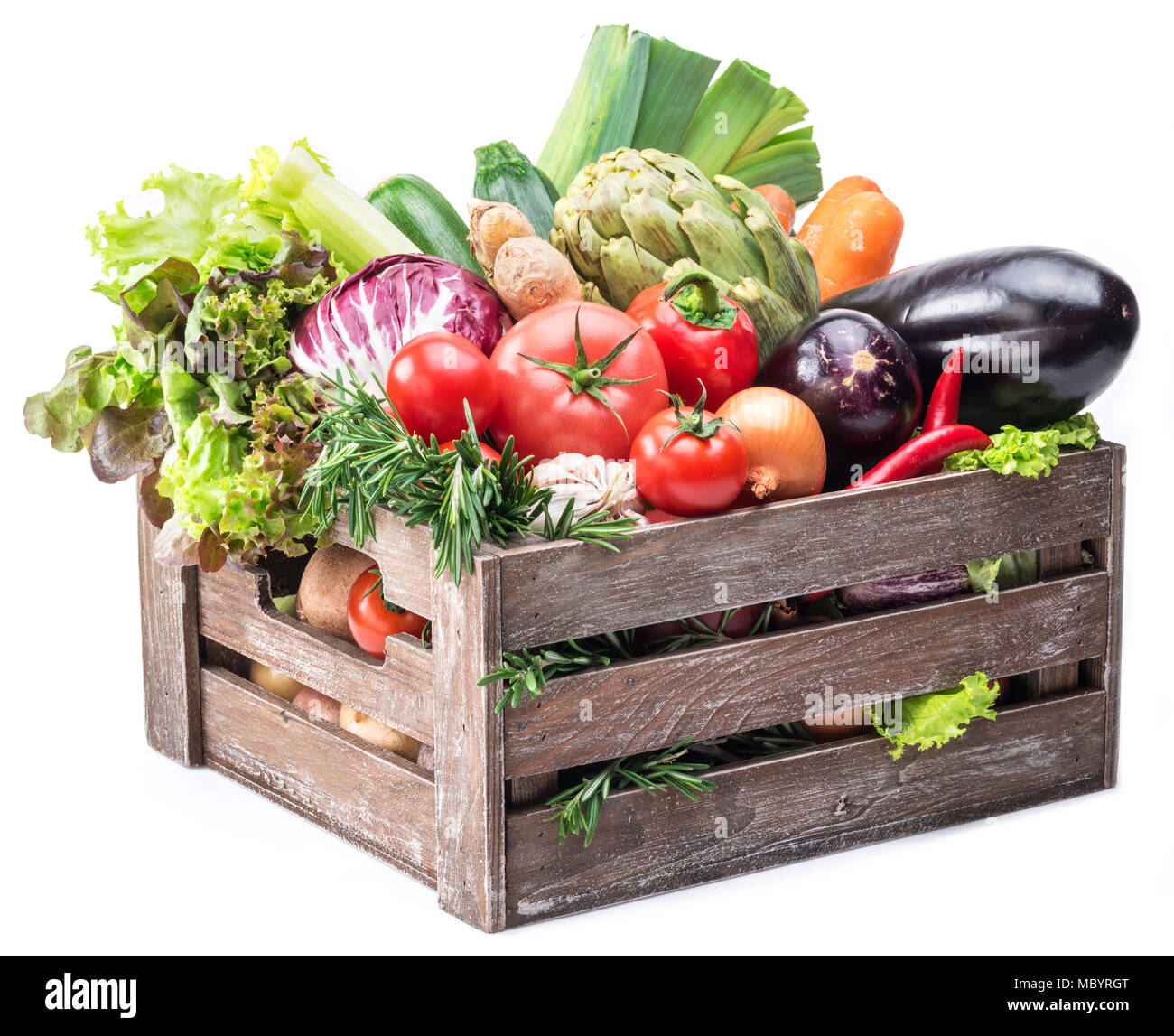 Fresh multi-colored vegetables in wooden crate. White background Stock ...