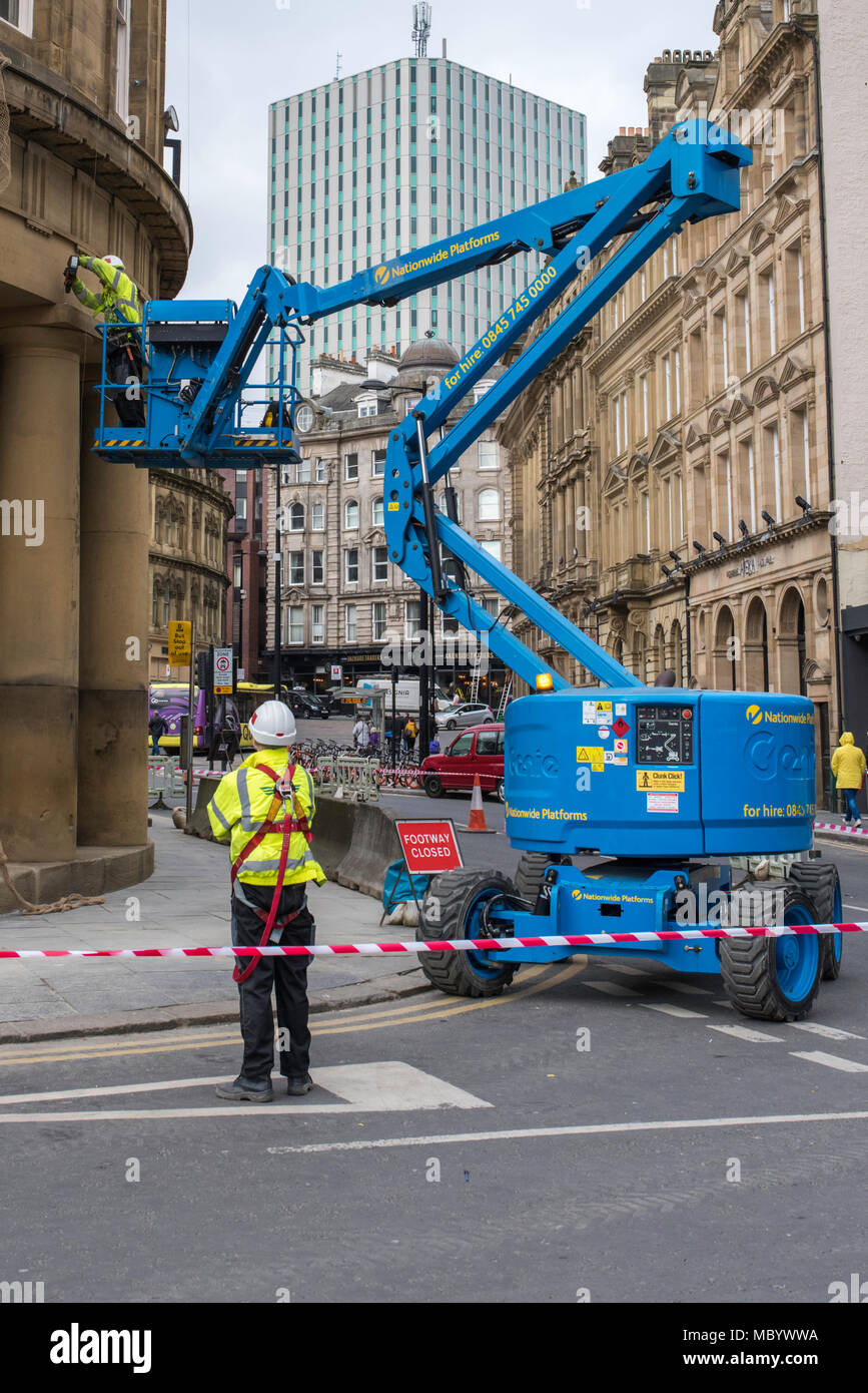 Cherry Picker with man repairing a building in Newcastle city centre ...