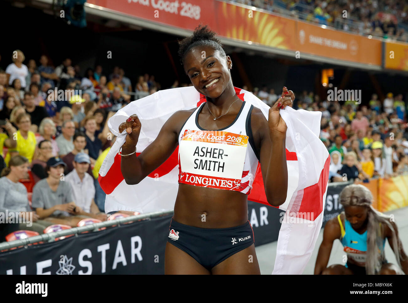 England's Dina Asher-Smith celebrates with her flag after winning ...