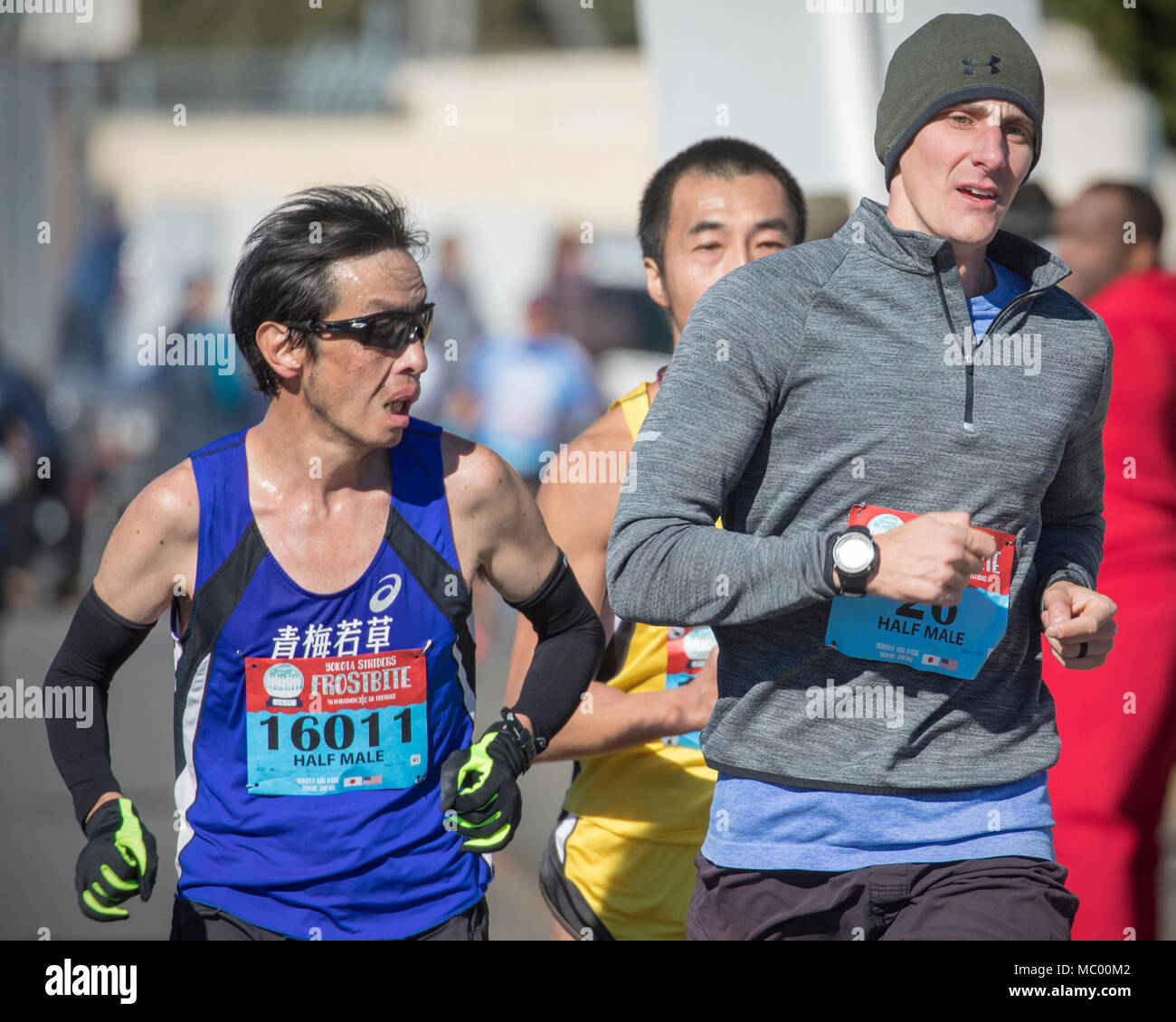 Capt. Noah Palicia, right, 36th Airlift Squadron C-130J pilot, runs ...