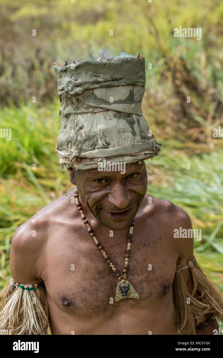 A Simbu fire-maker with traditional smoking headdress, Mount Hagen ...