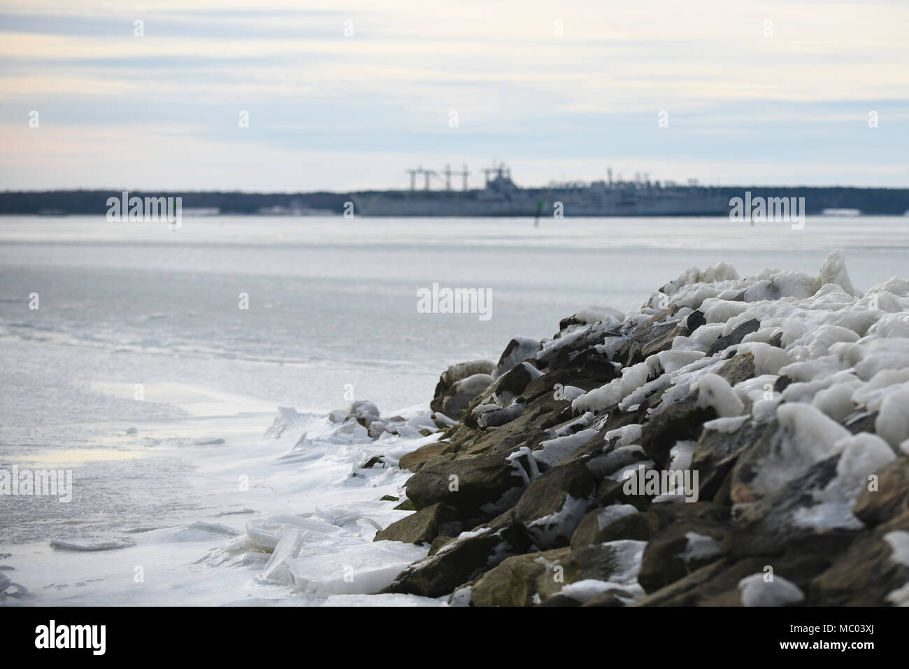 Ice forms on the rocks of a jetty on the James River after Winter Storm ...
