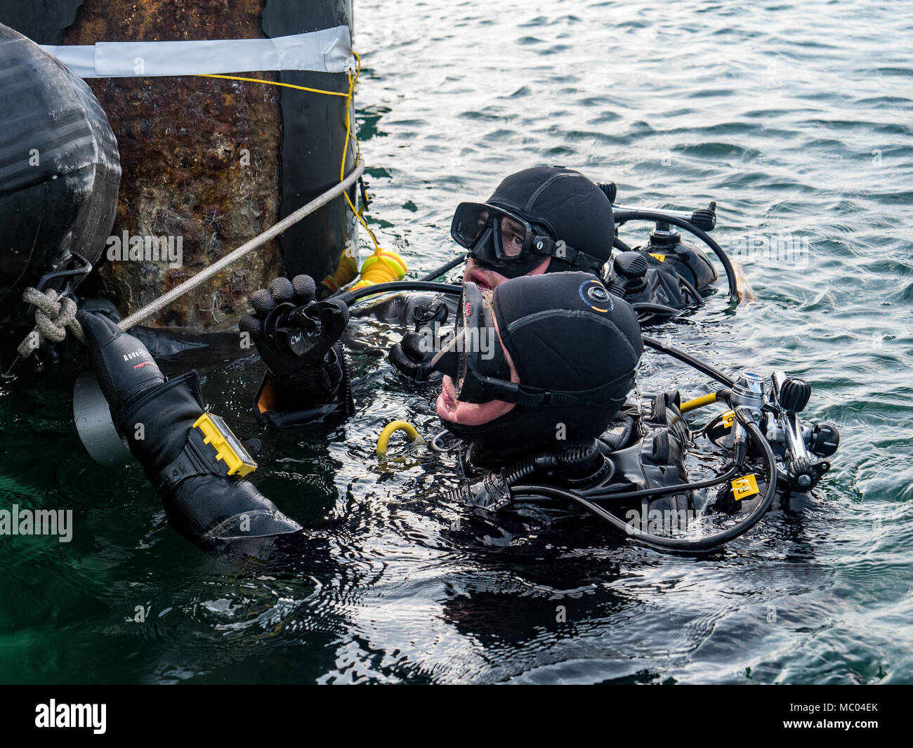 U.S. Navy Construction Electrician 2nd Class Timothy Dailey (top) and U ...