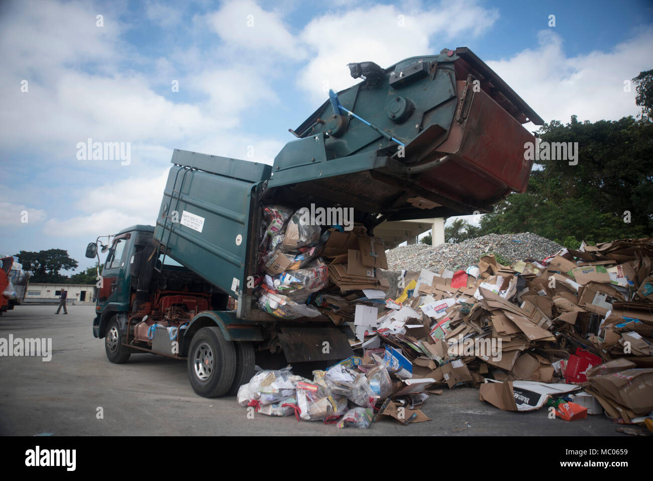 A garbage truck unloads paper and cardboard in a mass cardboard ...