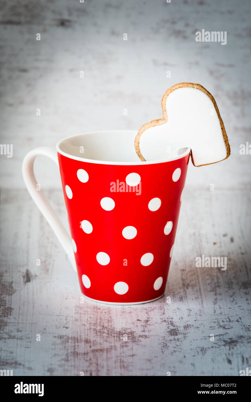 Valentines day concept. Coffee red polka dotted cup with a heart shaped ...