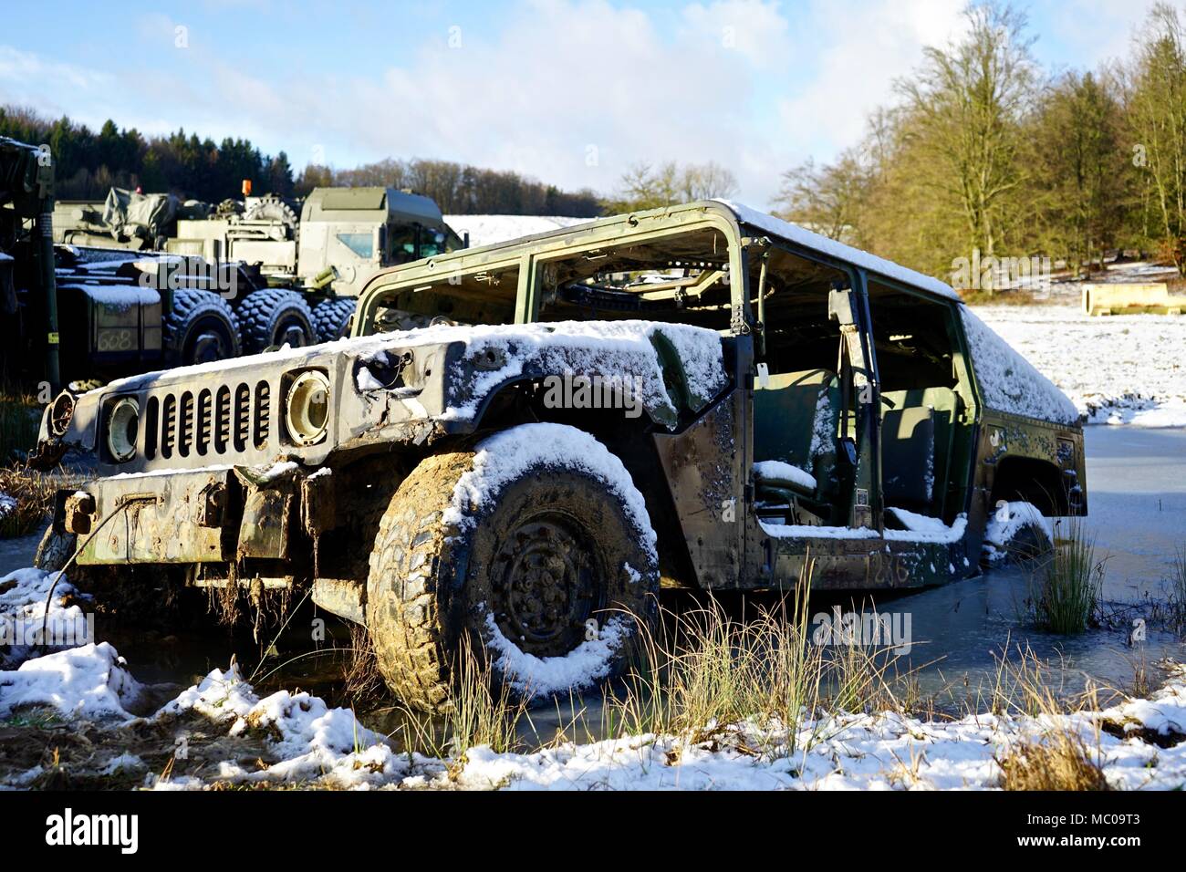 A Humvee sits in a pool of water awaiting recovery at Hogan’s Alley ...