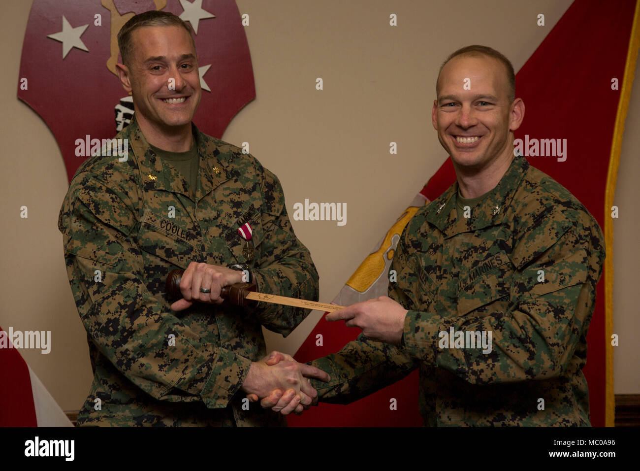 U.S. Marine Corps Maj. Jody L. Cooley, left, receives a gift from Col ...