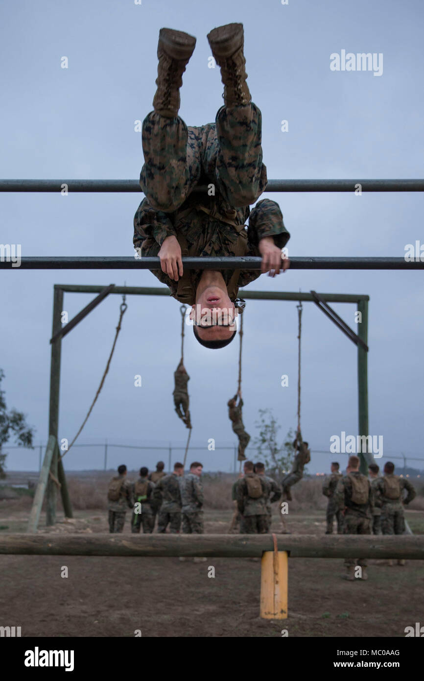 A U.S. Marine traverses the obstacle course during the Marine Corps ...