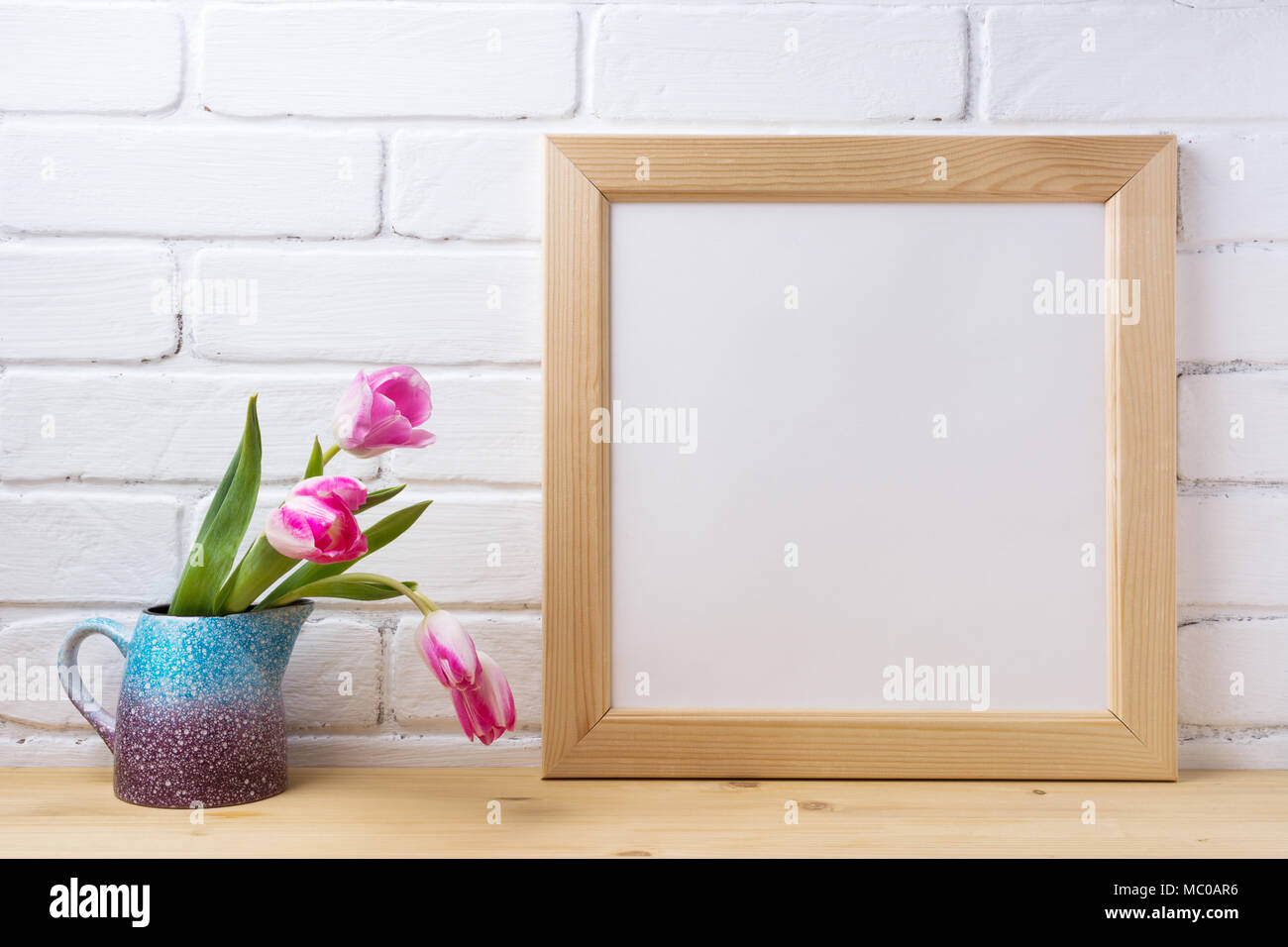 Wooden square picture frame mockup with pink tulip in the purple blue ...