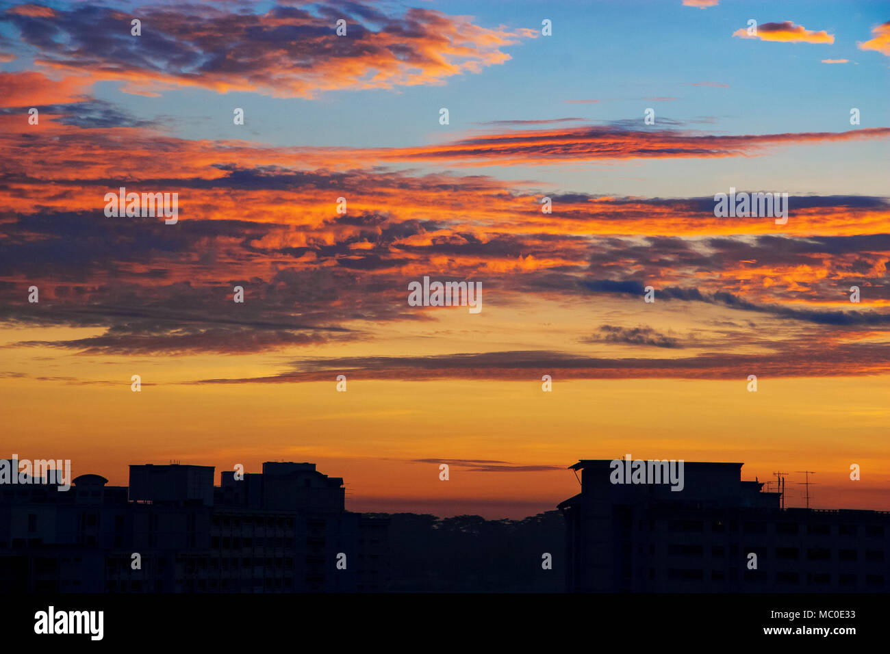Dramatic Orange Tone Sun Set with Roof Top Stock Photo - Alamy