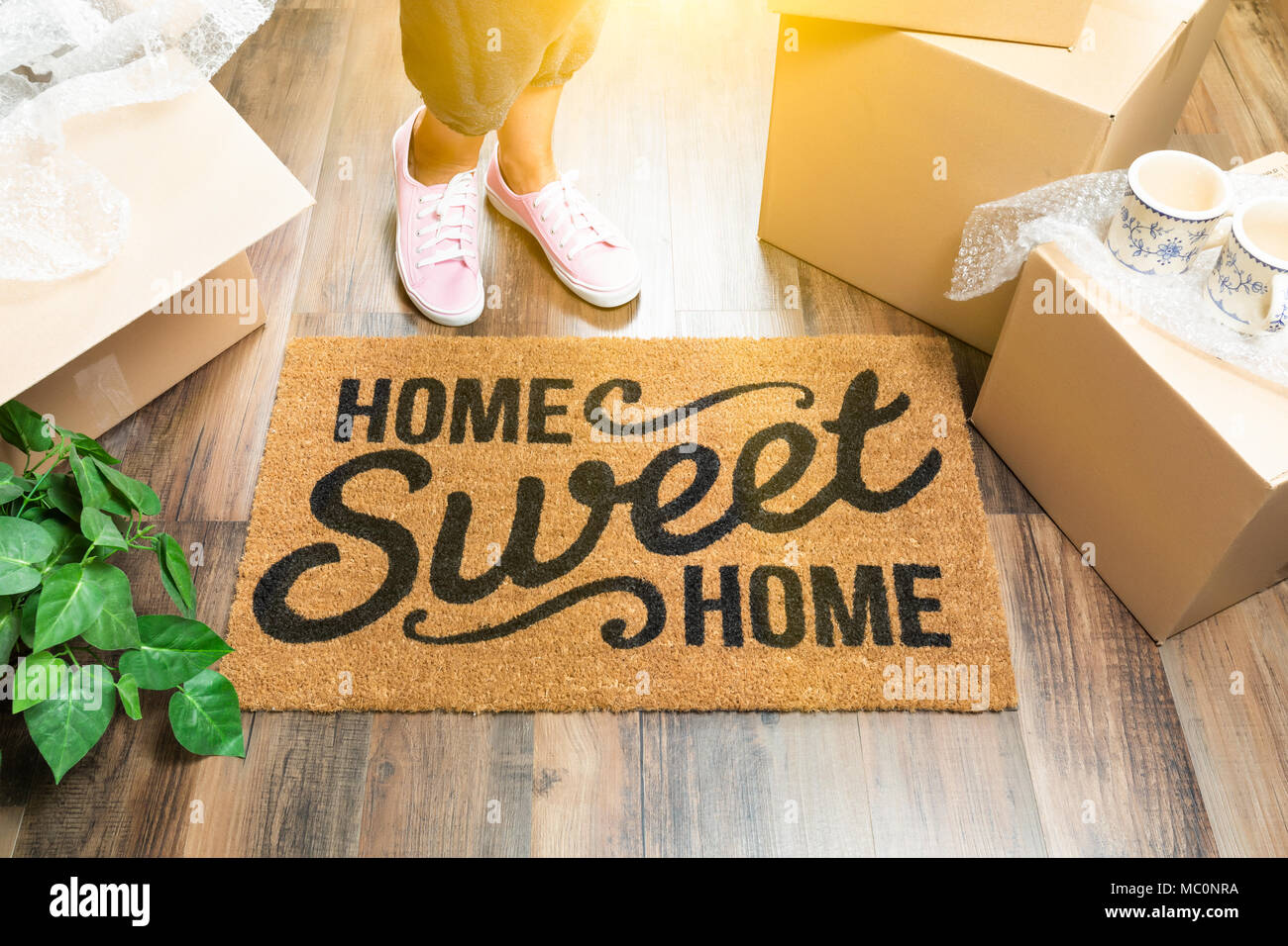 Woman greeting in door hi-res stock photography and images - Alamy