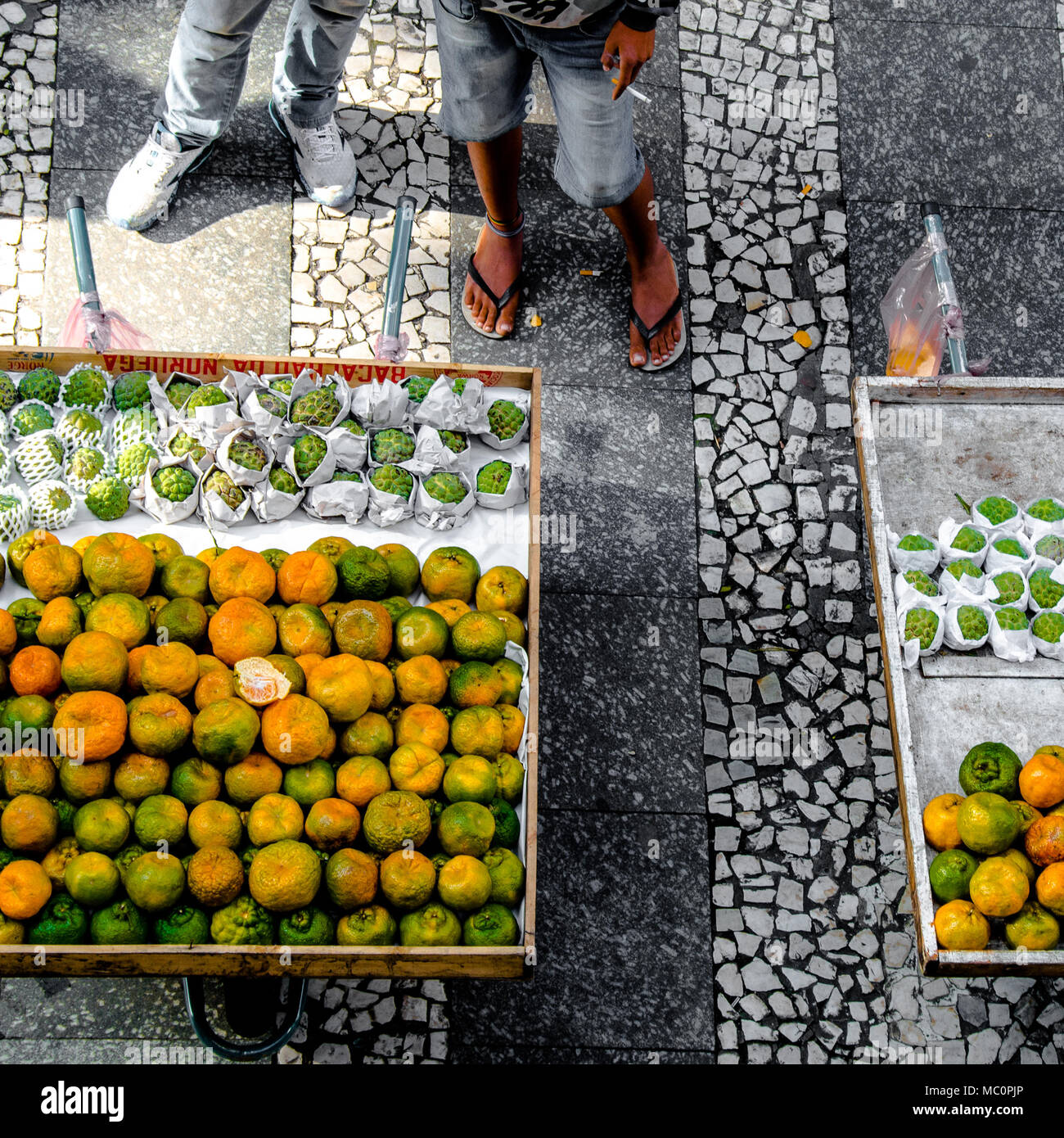 Two boys selling tangerine in an outdoor street fruit market, in São ...