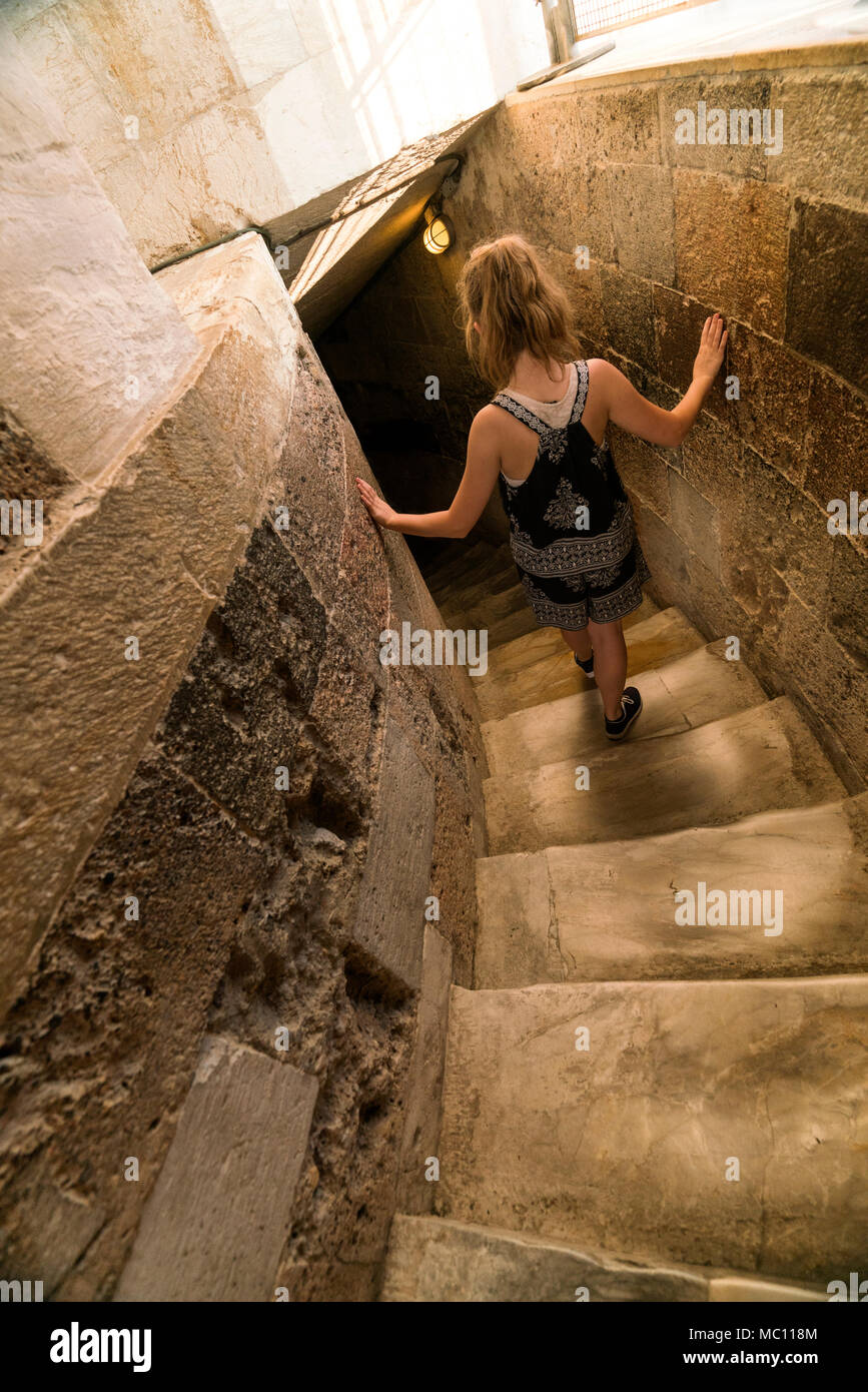 Teen girl climbs down the 274 weathered, worn and slanted marble steps ...