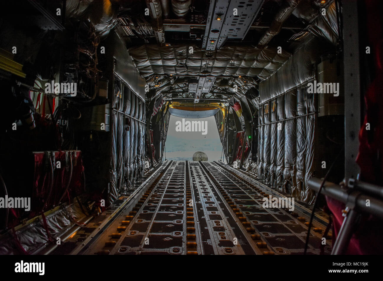 The parachute from the heavy drop from a C-130 can be seen out the back ...