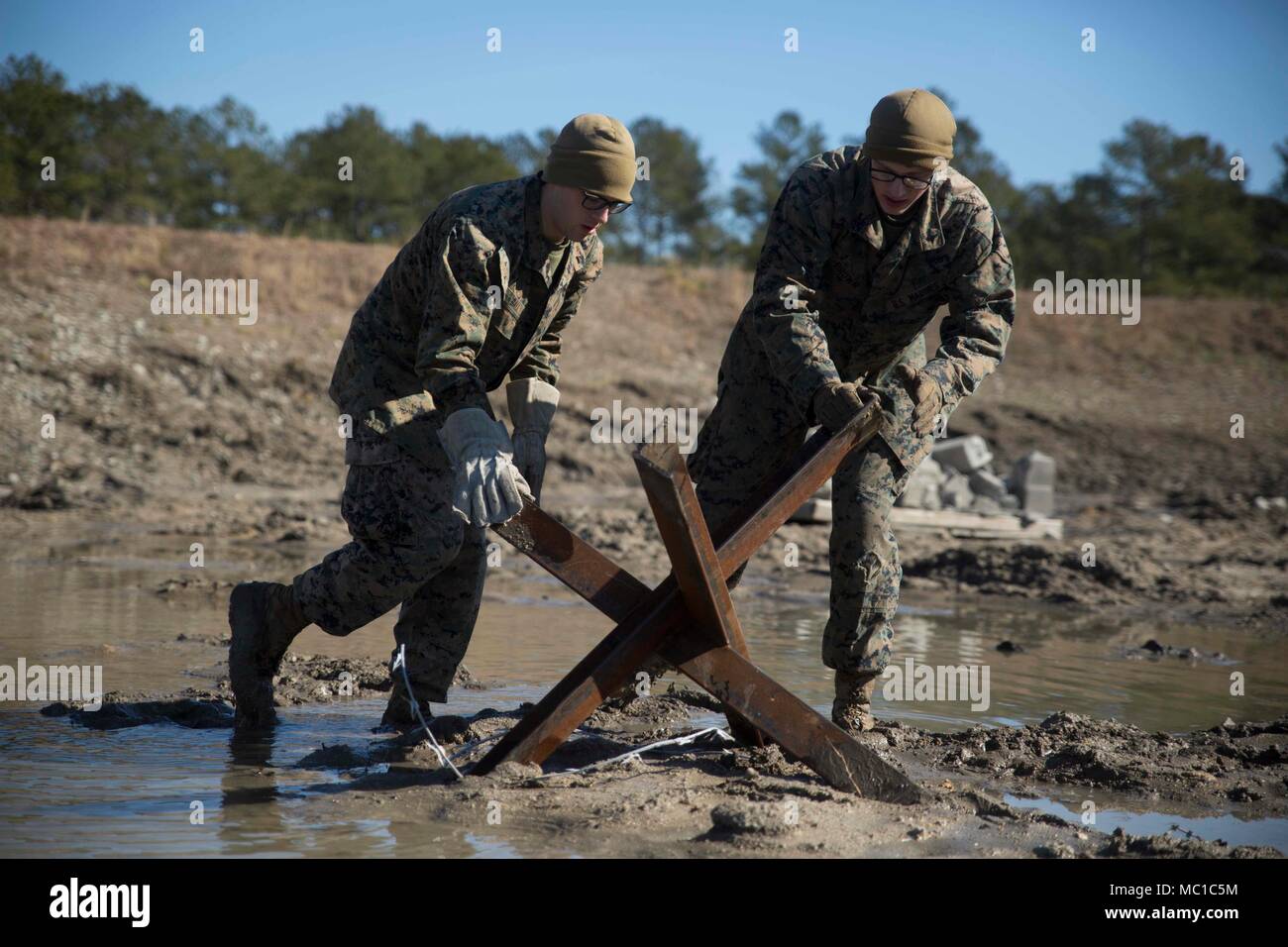 Pfc. Hunter Ball and Lance Cpl. Alan Brown place a barrier during a ...