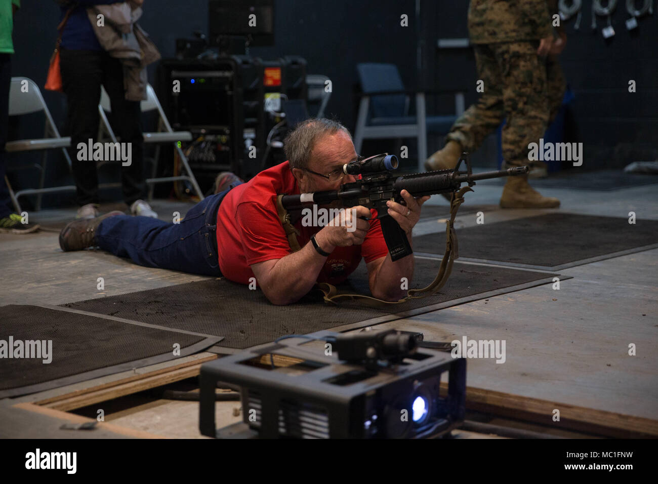 Dave Glynn from Cedar Rapids, Iowa, shoots a mock M16-A4 rifle at the ...