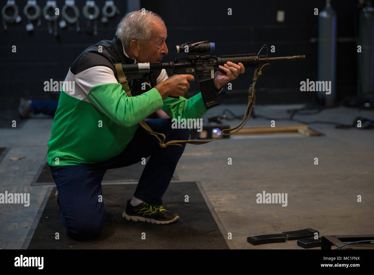 Bill Glynn from Boise, Idaho, shoots a mock M16-A4 rifle at the indoor ...