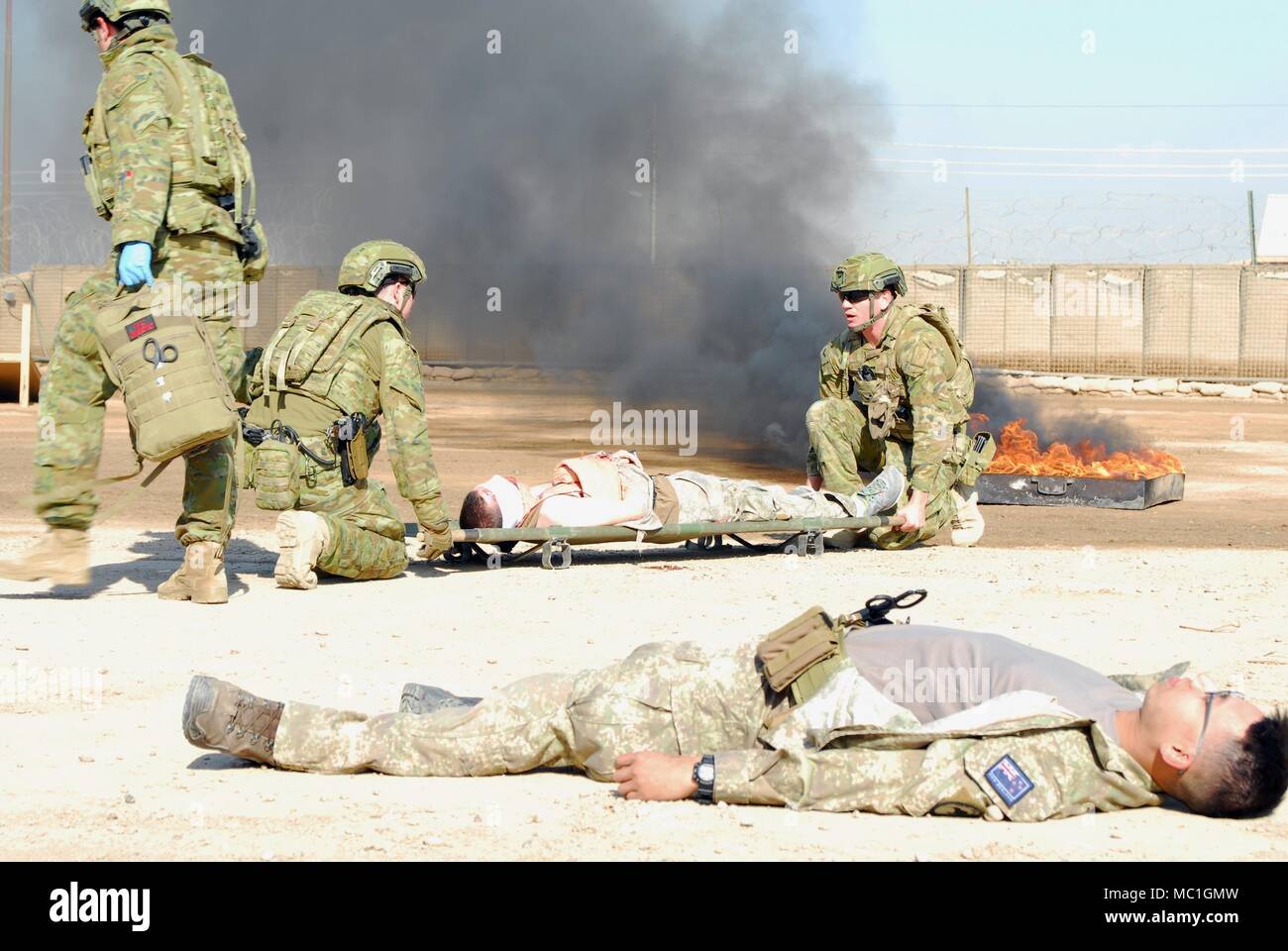Soldiers in the Australian army load a wounded soldier onto a litter to ...