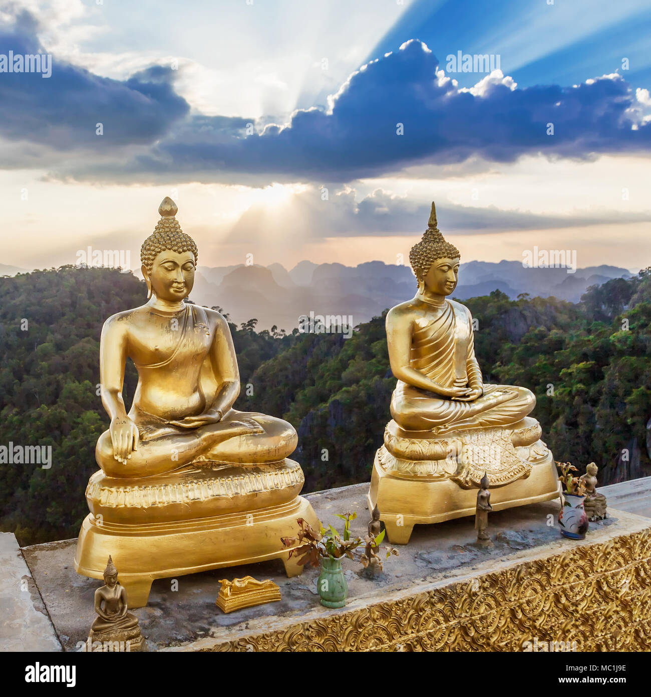 Buddha statues with beauty sunset background Stock Photo - Alamy